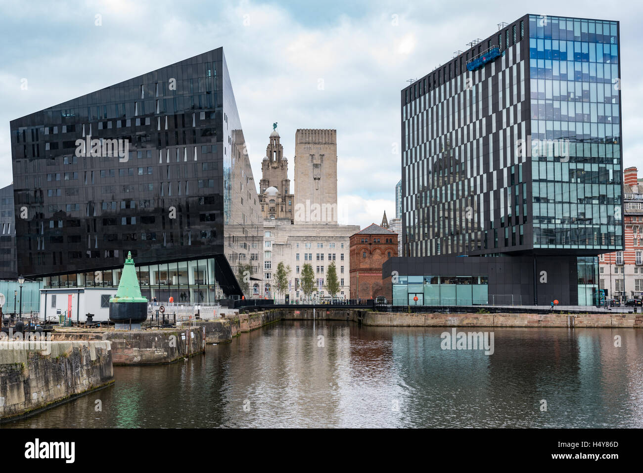 View of Liverpool's Three Graces blocked by and reflected in new modern ...