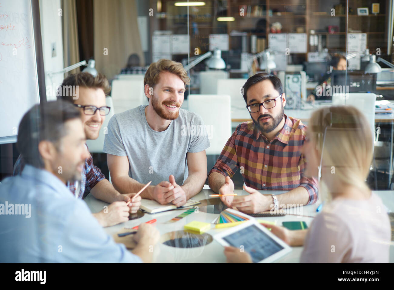 Confident employees having discussion of ideas Stock Photo - Alamy