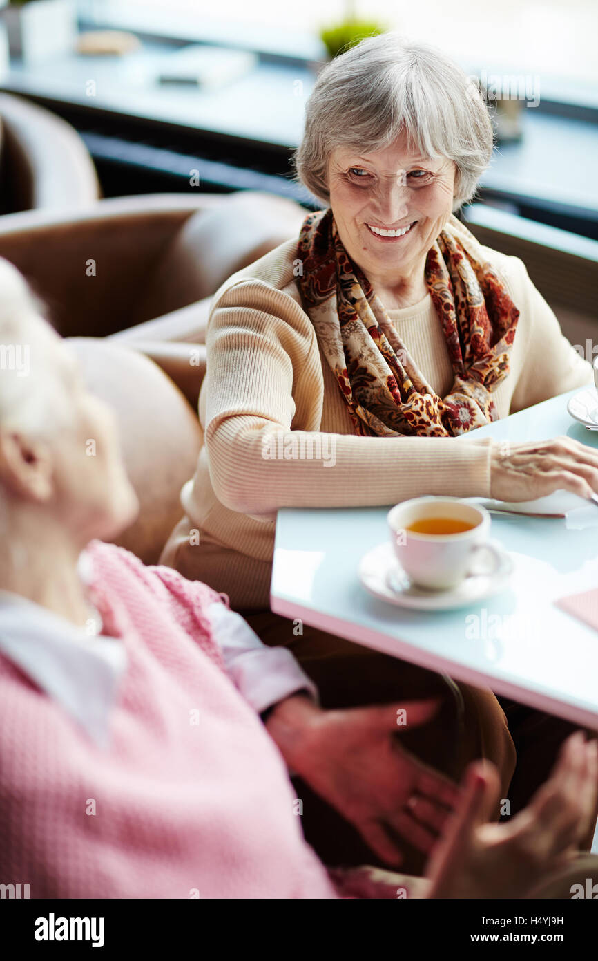 Elderly females talking by tea in cafe Stock Photo - Alamy
