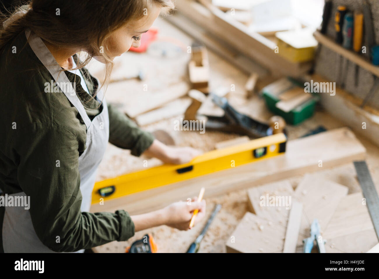 Young woman working as carpenter Stock Photo - Alamy