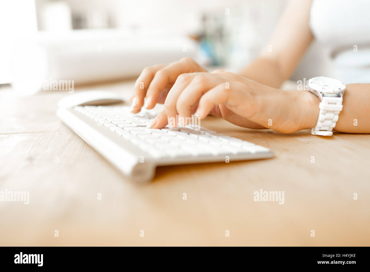 Young woman pressing keys while entering data Stock Photo - Alamy