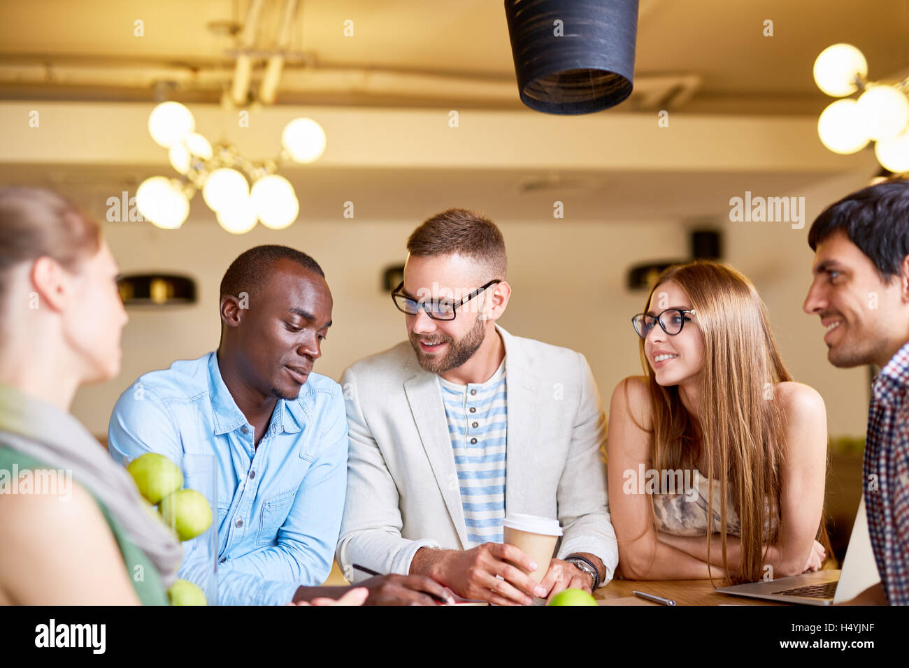 Intercultural group consulting about their work Stock Photo - Alamy
