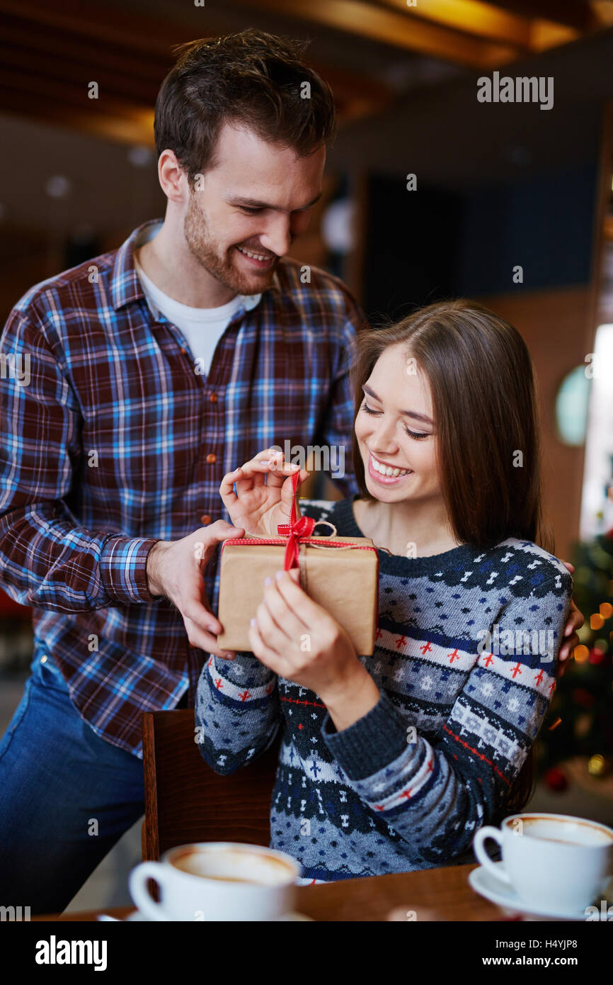 Happy female unpacking gift-box from her boyfriend Stock Photo - Alamy
