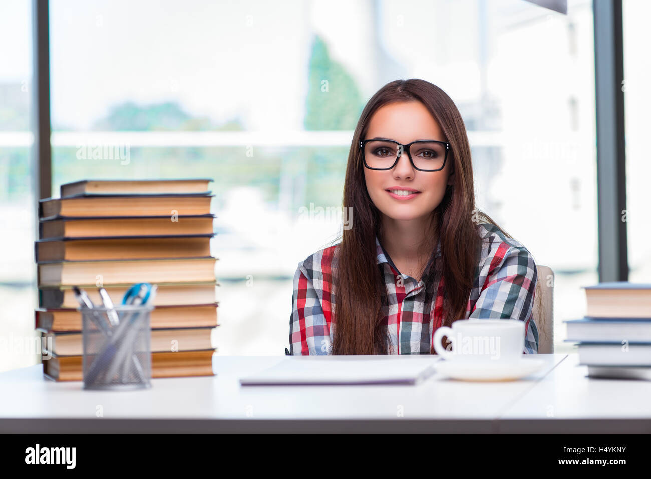 Young woman student with many books Stock Photo - Alamy