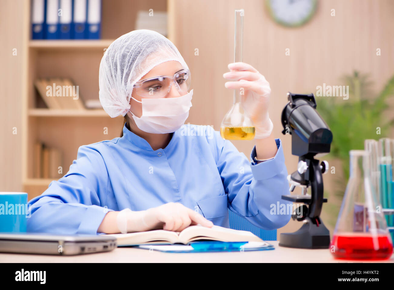 Lab chemist working with microscope and tubes Stock Photo - Alamy