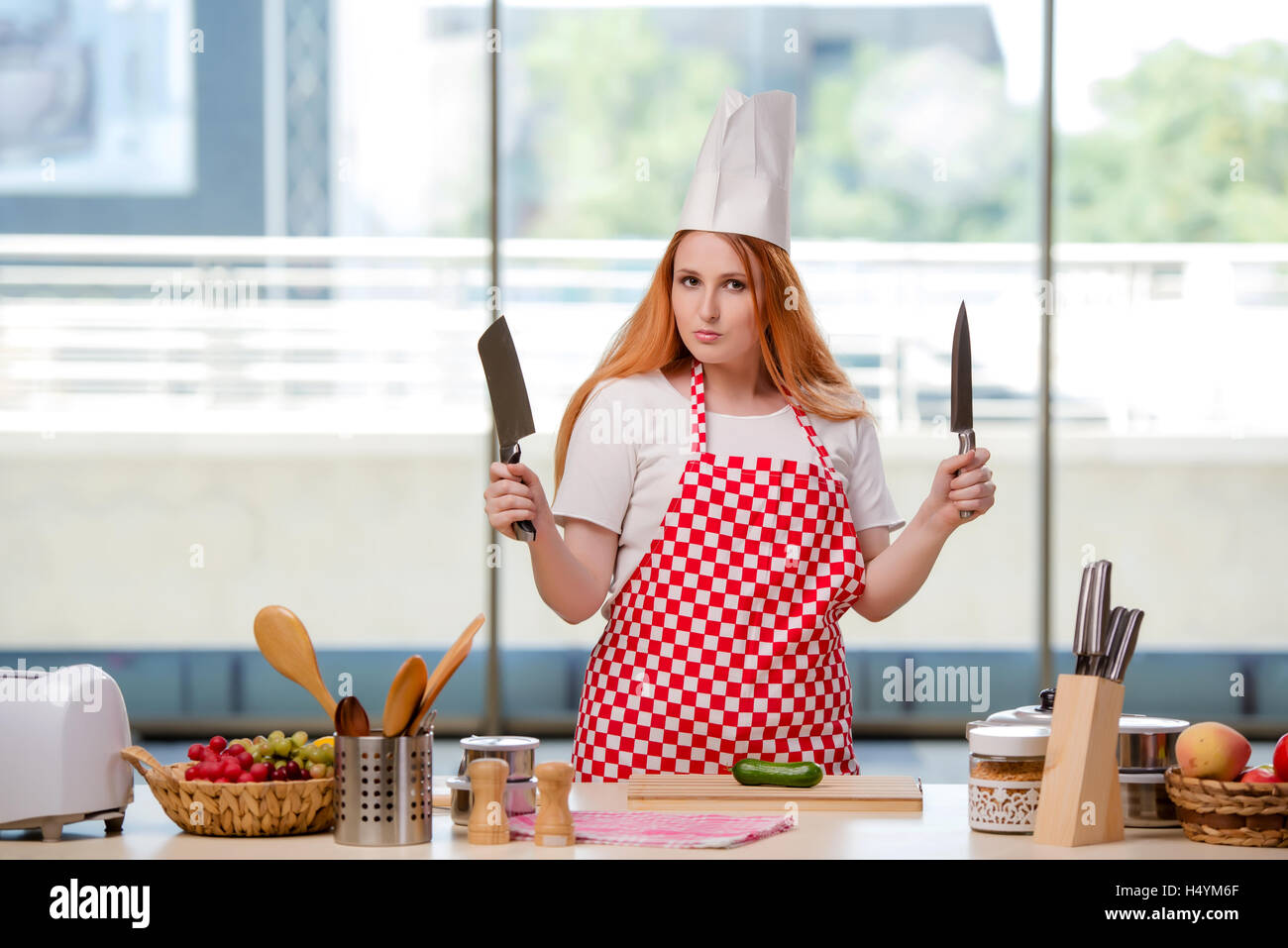 Redhead cook working in the kitchen Stock Photo - Alamy