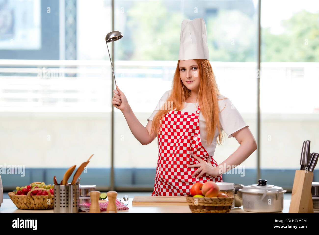Redhead cook working in the kitchen Stock Photo - Alamy