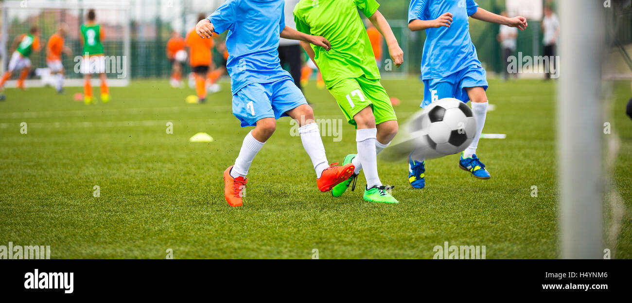 Kids playing football together; Children playing soccer outdoor Stock ...