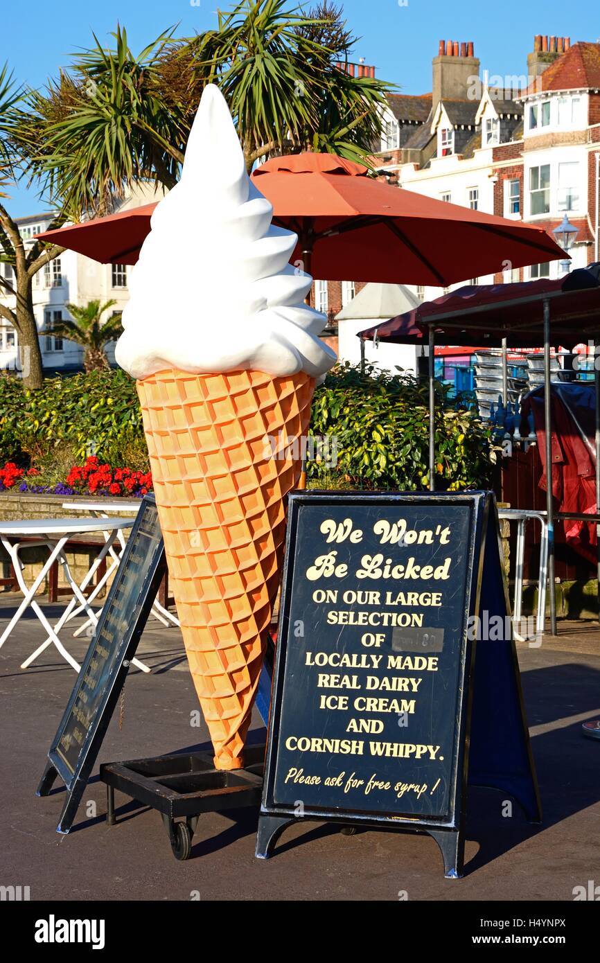 Large ice cream cone and menu boards outside an ice cream parlour along ...