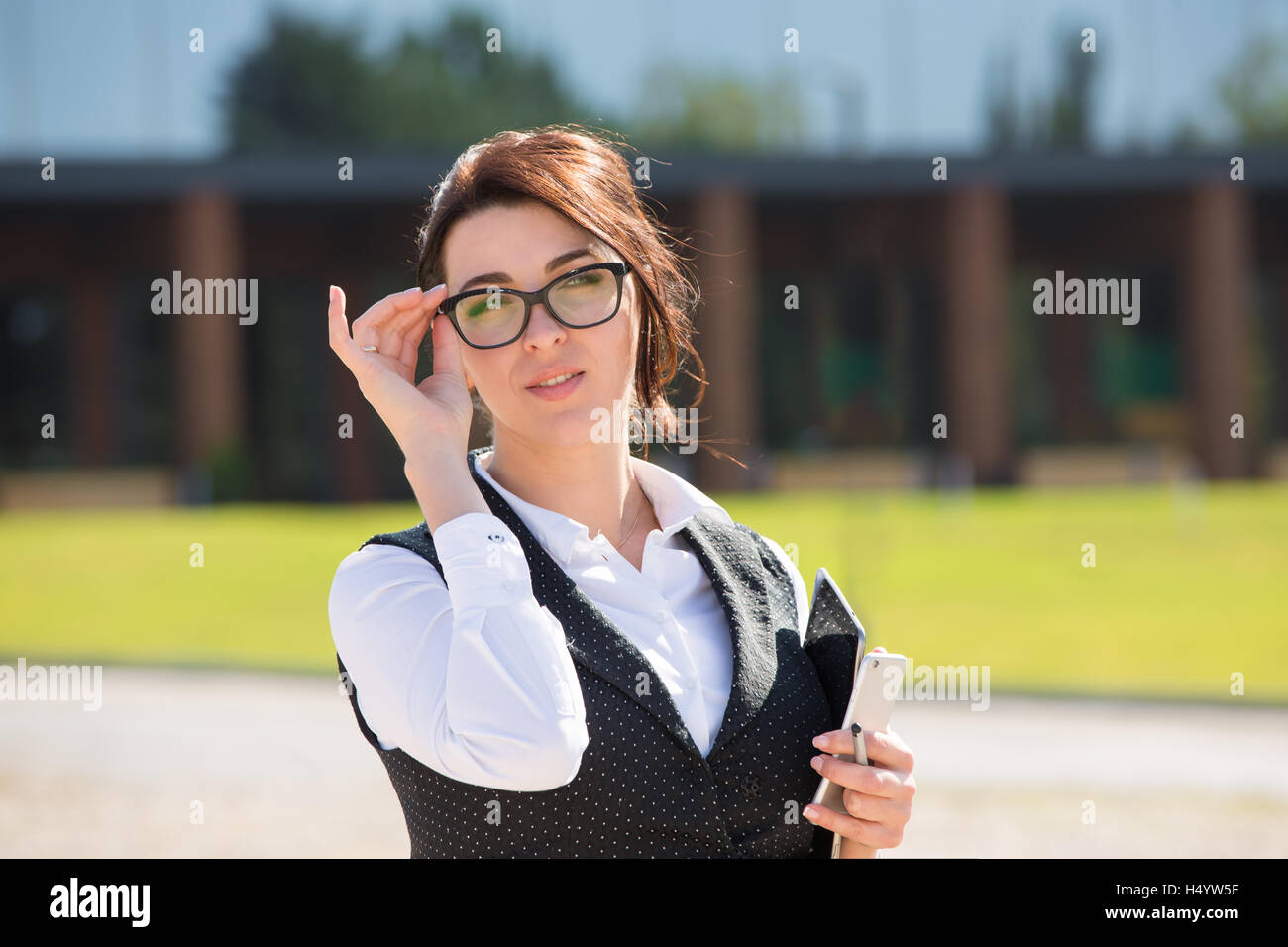Portrait of a young smiling business woman Stock Photo - Alamy Portrait of a young smiling business woman Stock Photo - Alamy