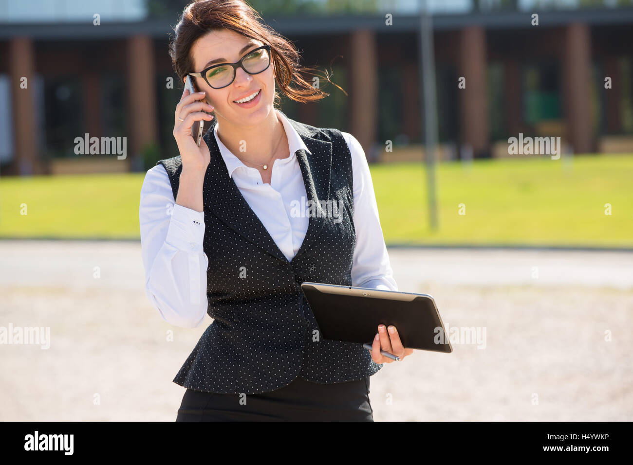 Portrait of a young smiling business woman Stock Photo - Alamy Portrait of a young smiling business woman Stock Photo - Alamy