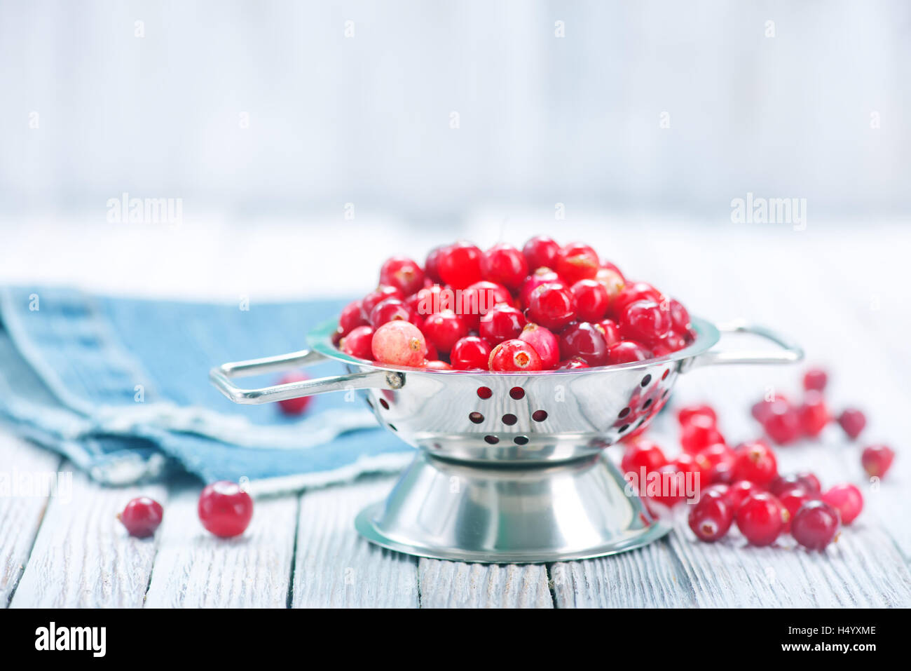 Cranberry in metal bowl and on a table Stock Photo - Alamy