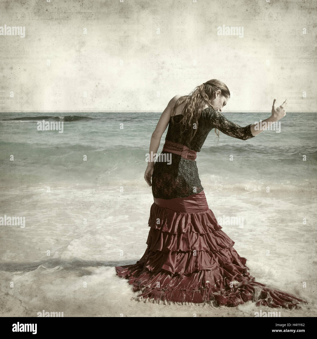 textured old paper background with flamenco dancer by the ocean shore ...