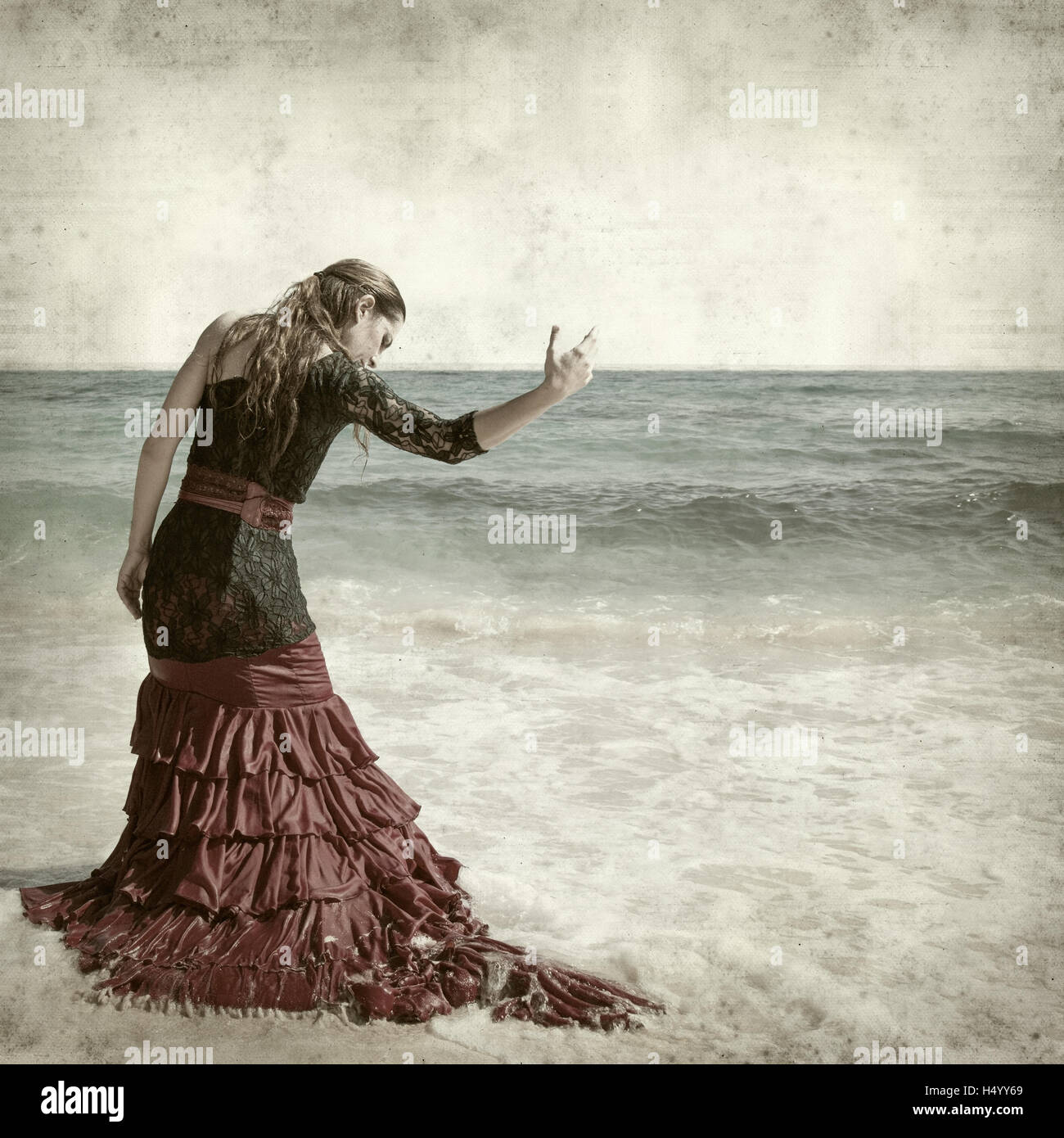 textured old paper background with flamenco dancer by the ocean shore ...