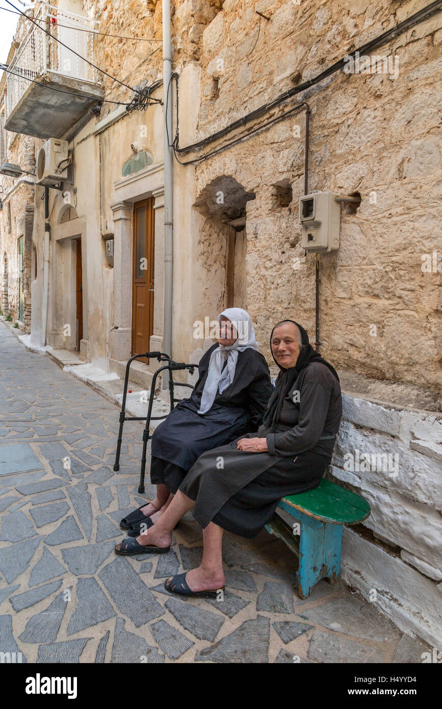 Street scene with Greek women chatting Pyrgi vllage Chios Island Greece ...