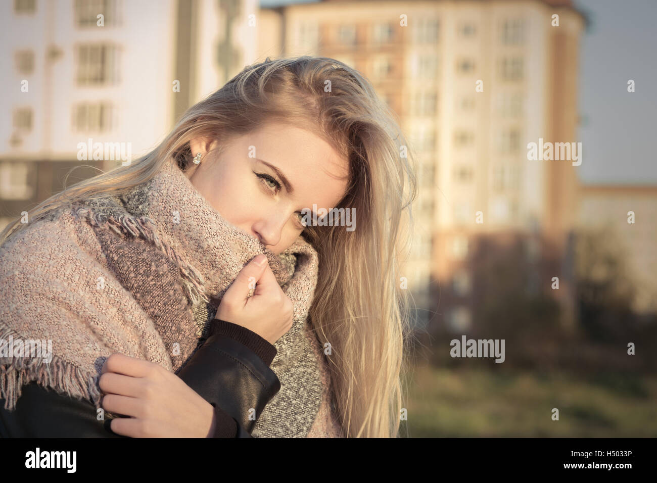 sad pensive blond girl in scarf toned image Stock Photo - Alamy