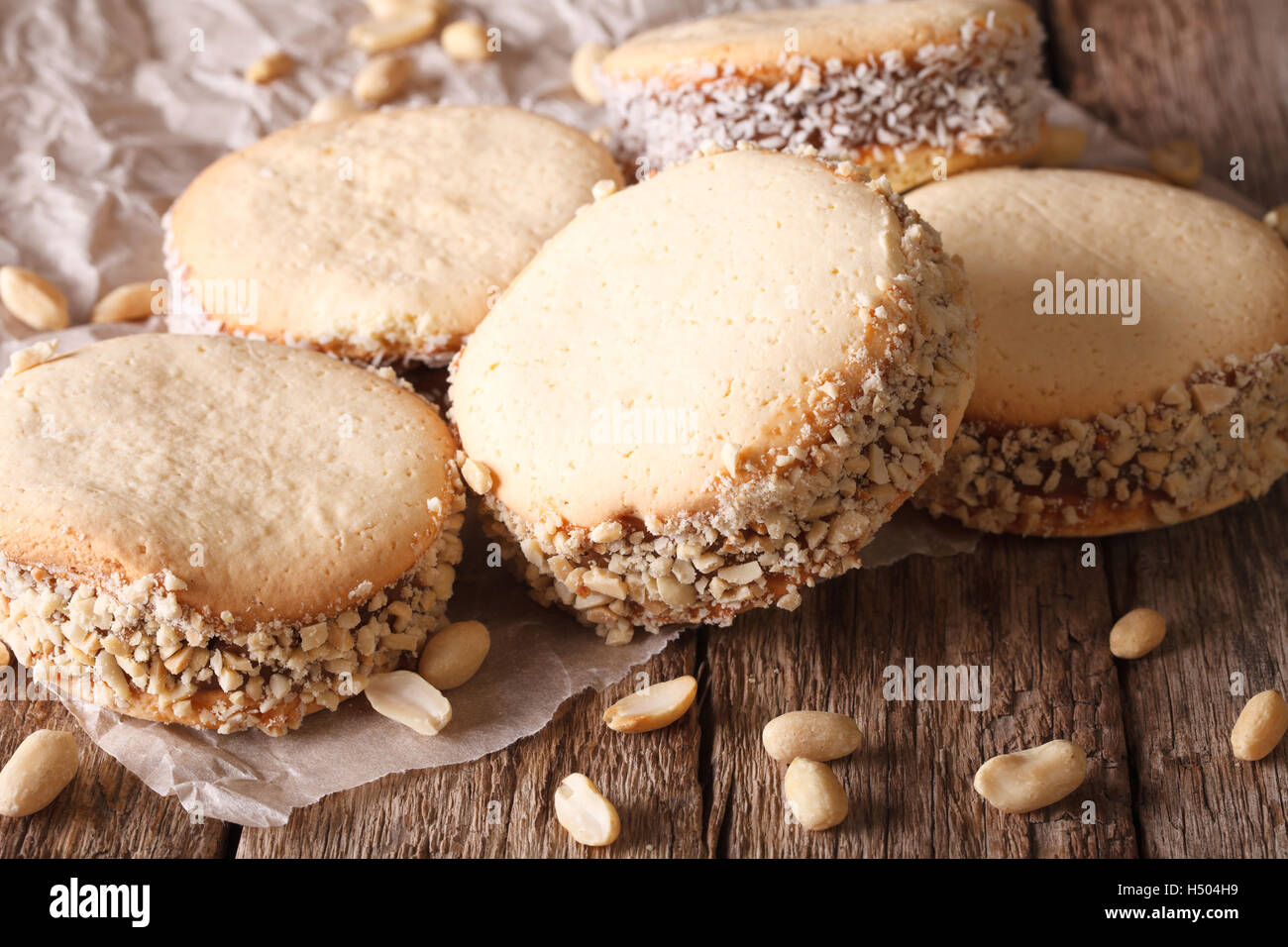 Delicious Argentinian cookies alfajores with cream on paper close-up on ...