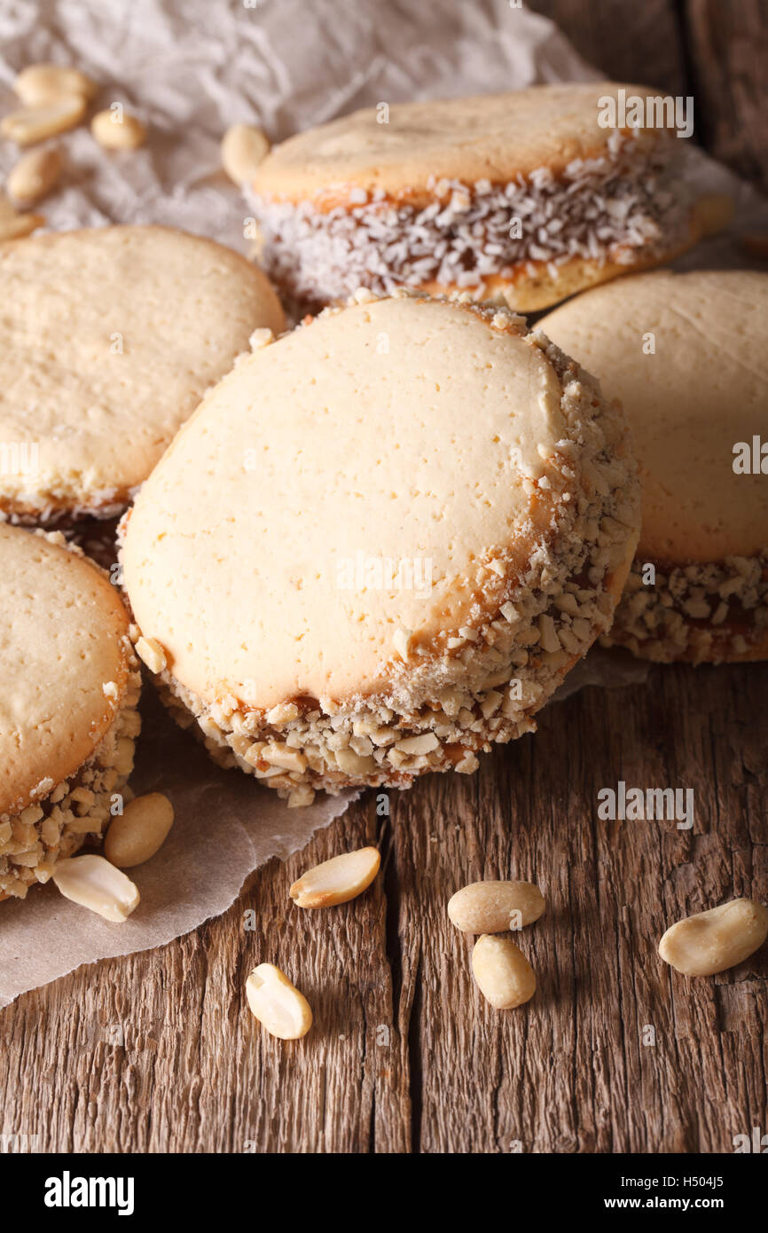 Delicious Argentinian cookies alfajores with cream on paper close-up on ...