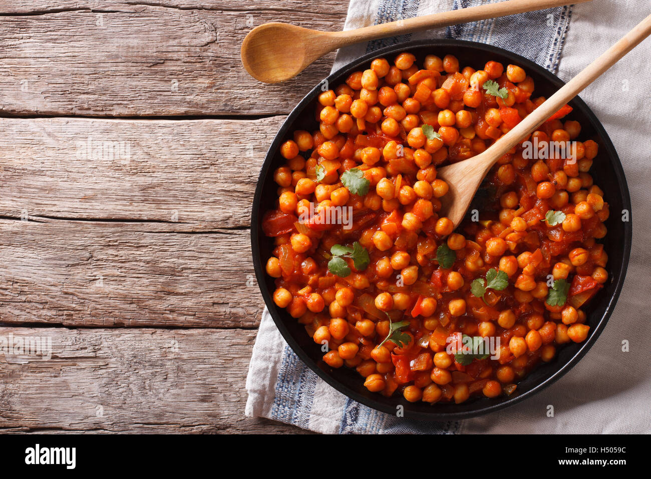 Indian Food Chana masala on a plate on the table. Horizontal top view ...