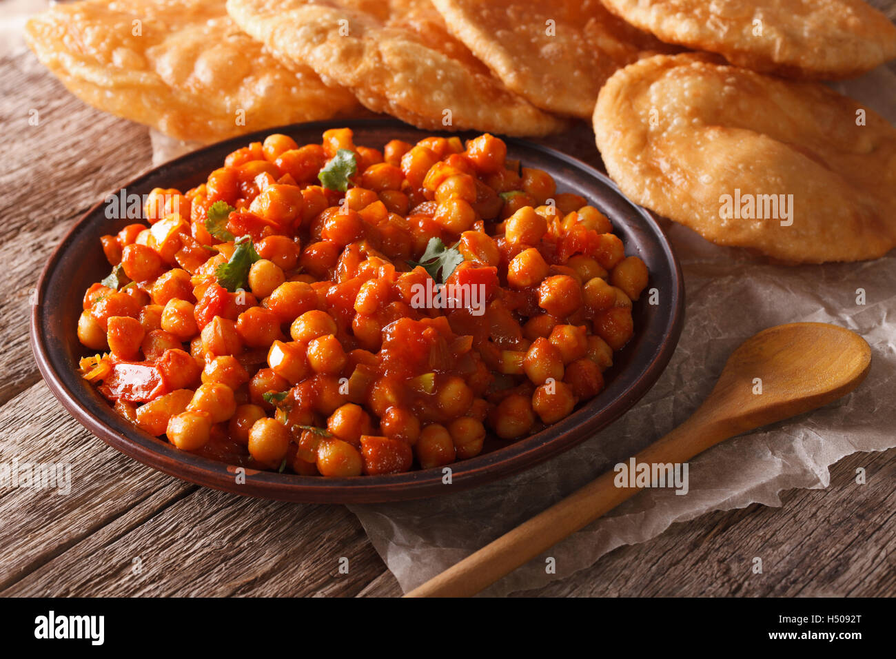 Indian Chana masala and puri bread close-up on the table. horizontal ...