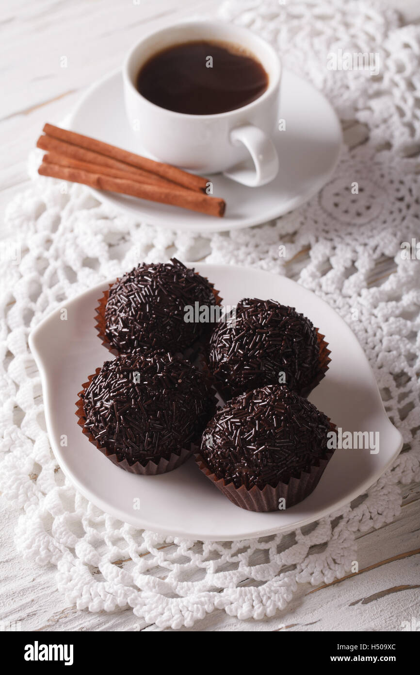 Brazilian candies on a plate and fragrant coffee close-up. vertical ...