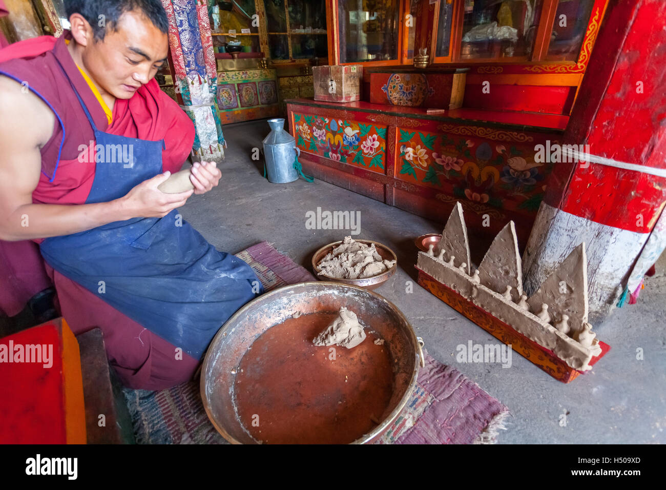 Young monk in Lhatse Chode Monastery is making torma cake Stock Photo - Alamy