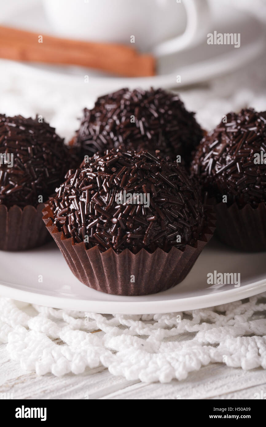 Brazilian chocolate candy Brigadeiro on a plate macro. Vertical Stock ...