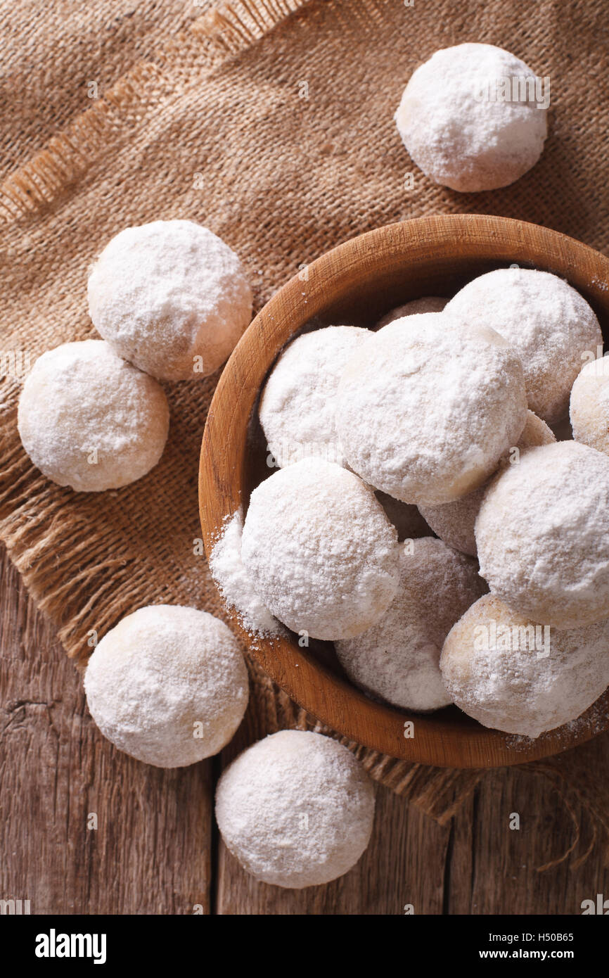 Shortbread polvoron close up in a wooden bowl on the table. vertical ...