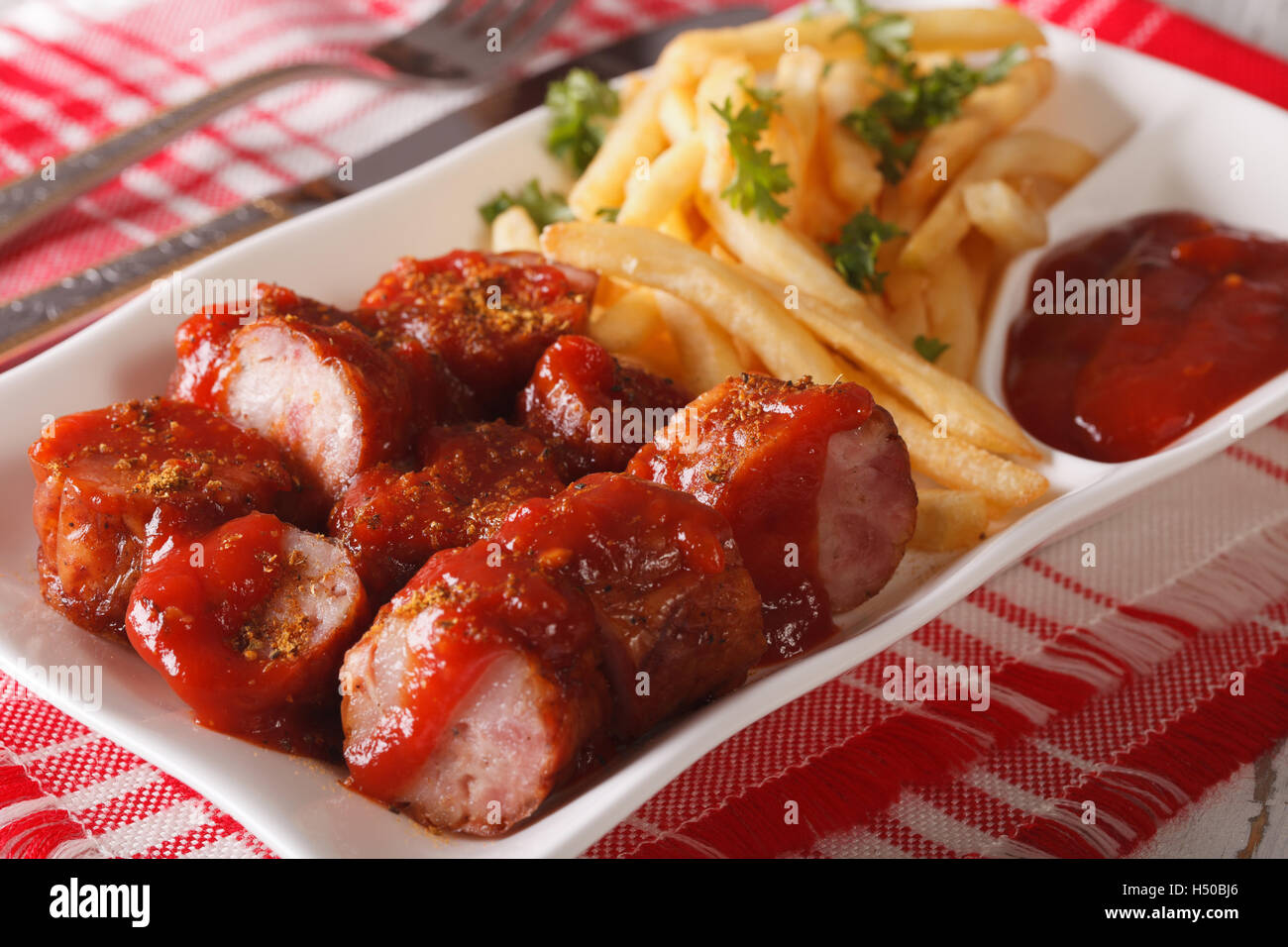 German cuisine: currywurst with french fries close-up on a plate ...