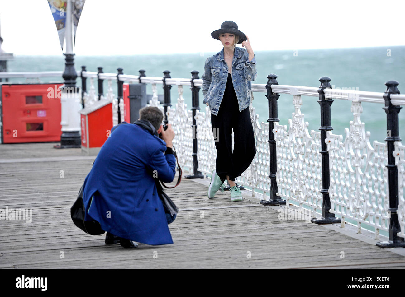 A photographer photographing Attractive young female model wearing ...