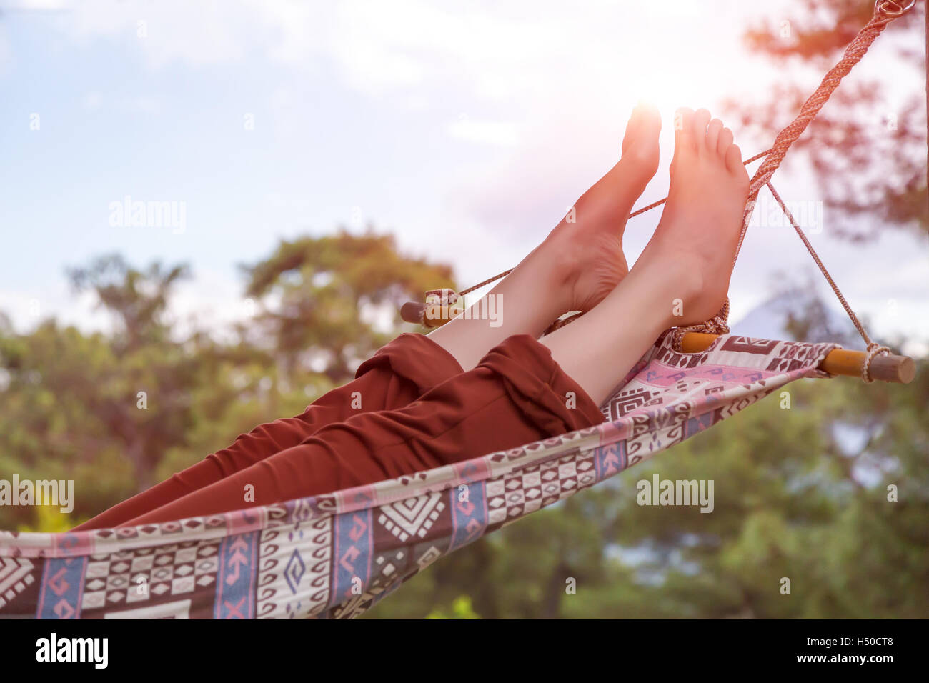Person relaxing lying in Hammock at rural cottage garden Stock Photo ...