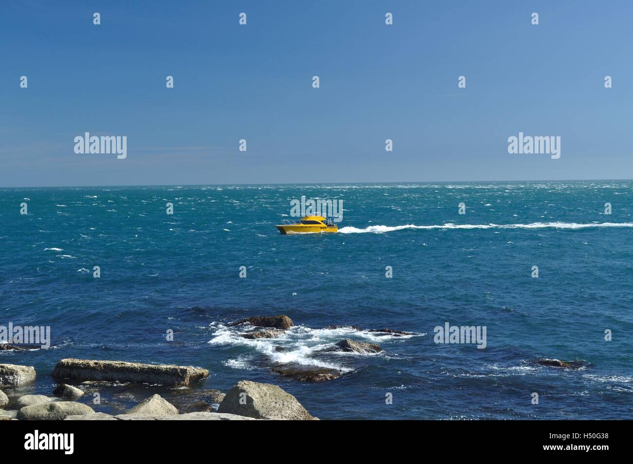 A small boat hurries through the dangerous waters of Portland Race on a ...