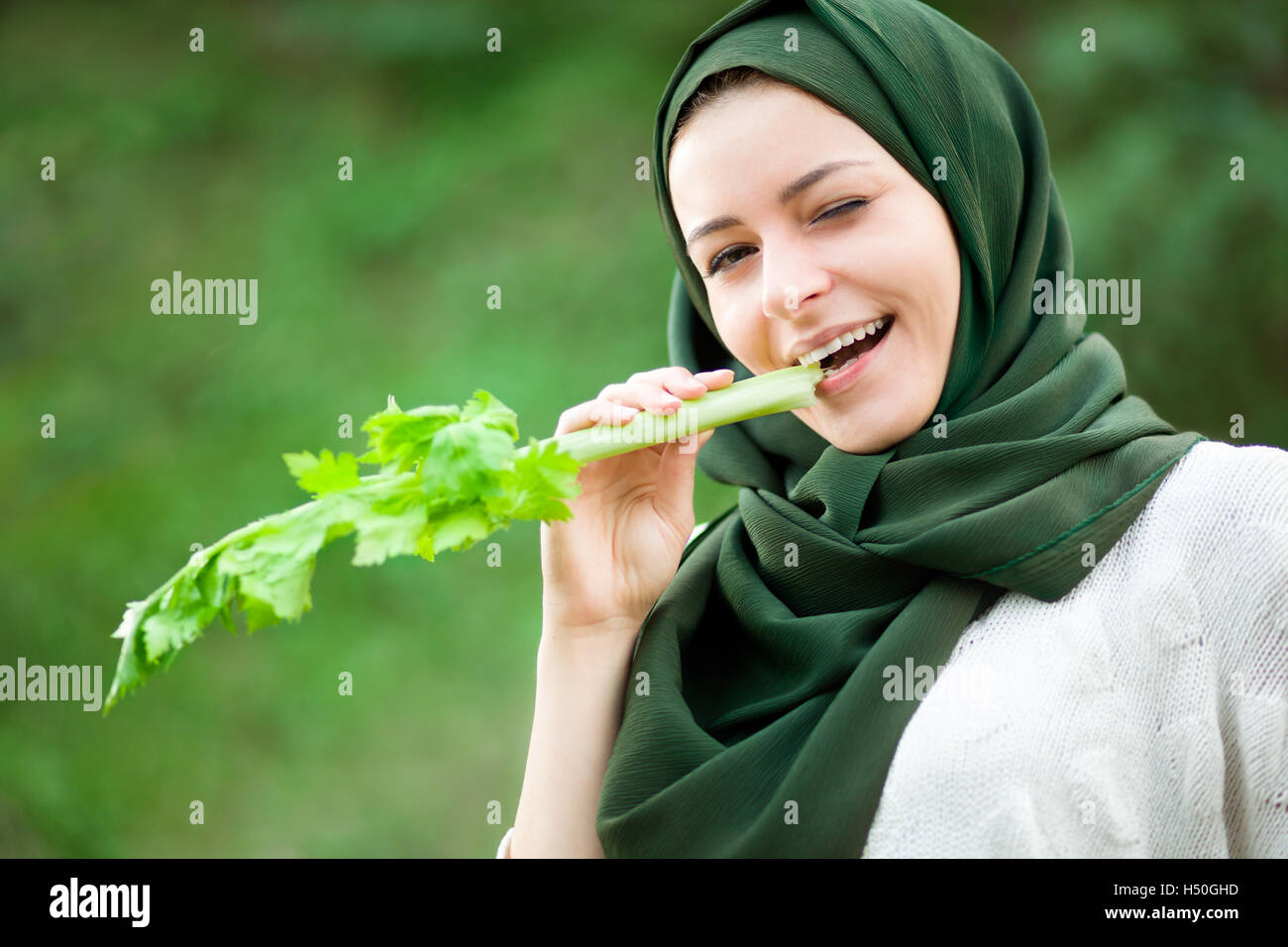 Muslim Vegan Woman with Veil Eating a Celery Stock Photo - Alamy