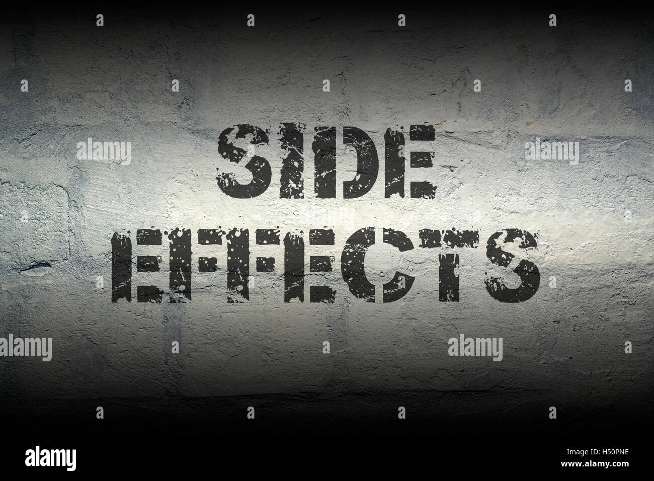 side effects stencil print on the grunge white brick wall; specially ...