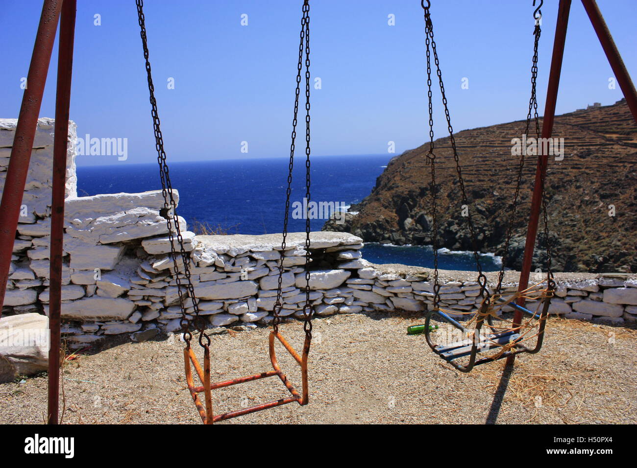 Old rusty Swing seats in Sifnos island, Greece Stock Photo - Alamy