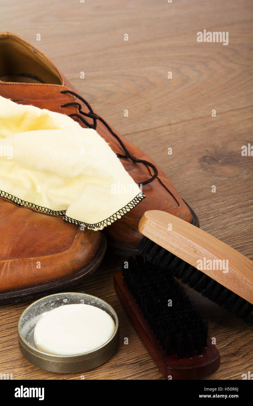 Shoes and cleaning equipment on a rustic wooden floor Stock Photo - Alamy