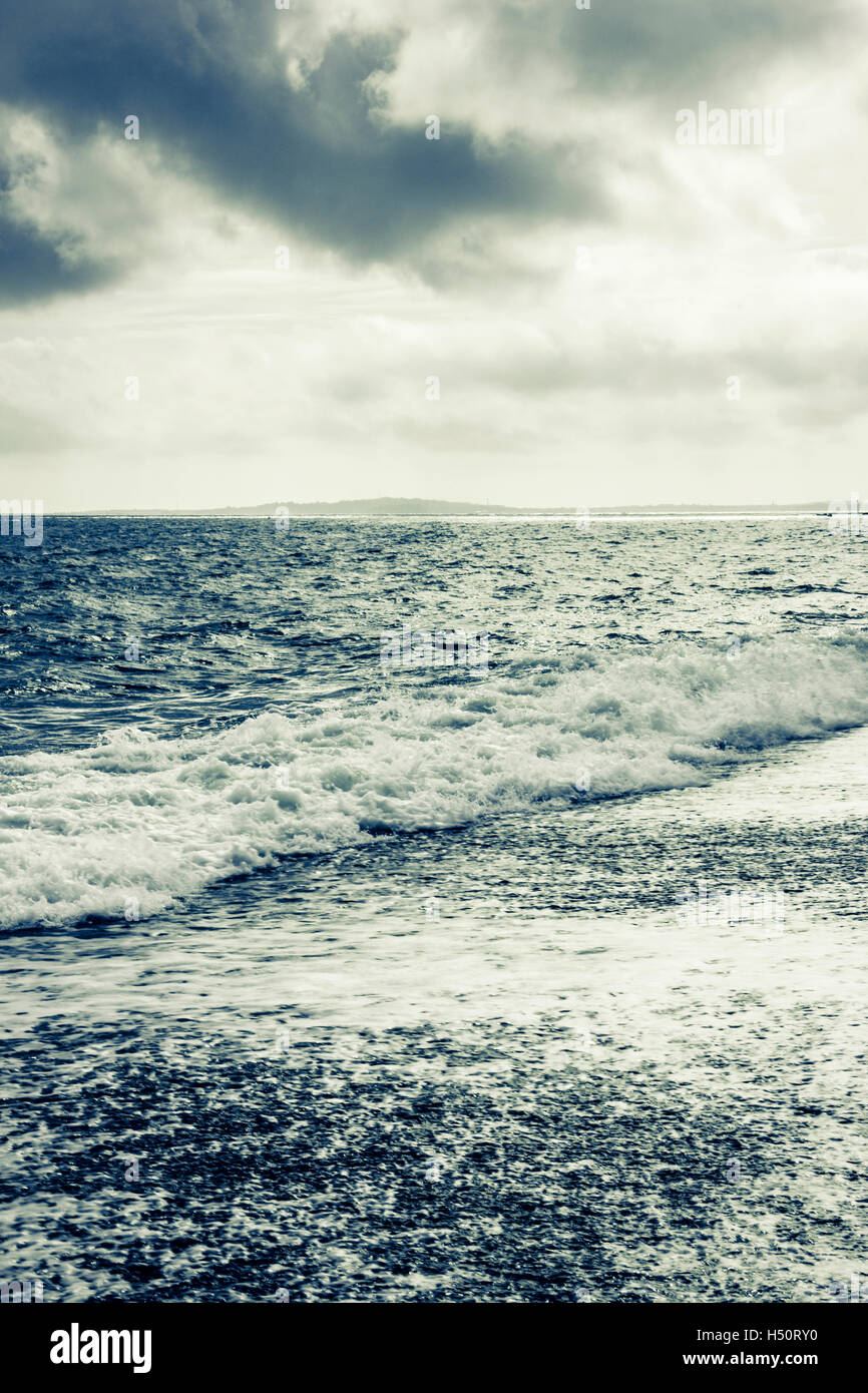 Blue green toned image of weather closing in and choppy sea, Ringstead ...