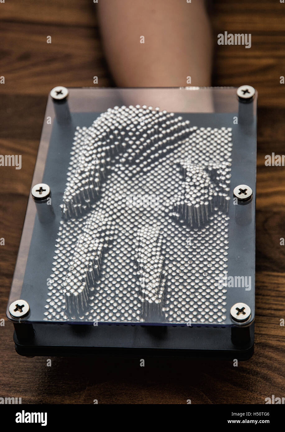 Victory sign on hand pressed to pin board toy forming. Leisure activity ...