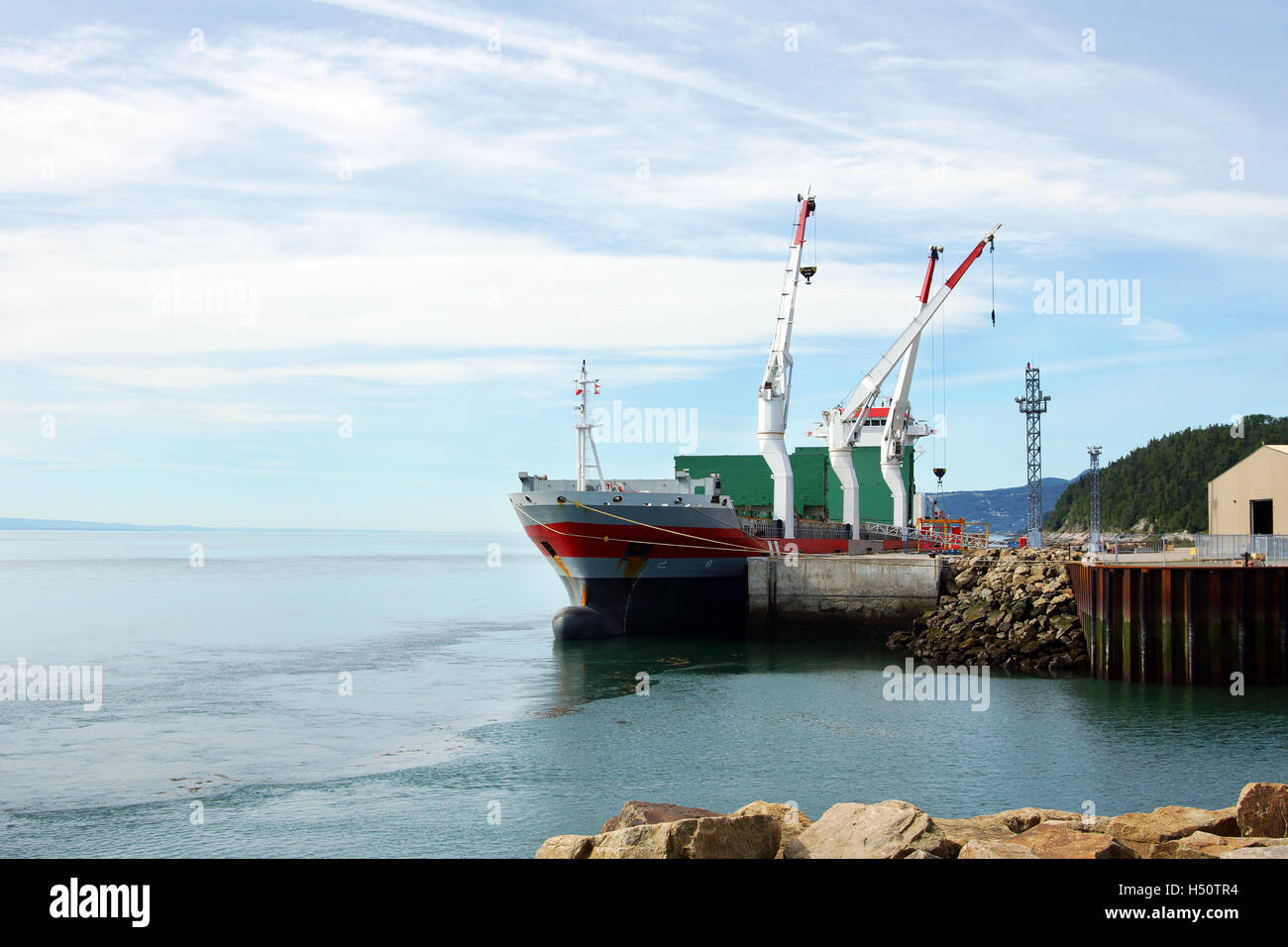 Small seaport with docked cargo ship Stock Photo - Alamy