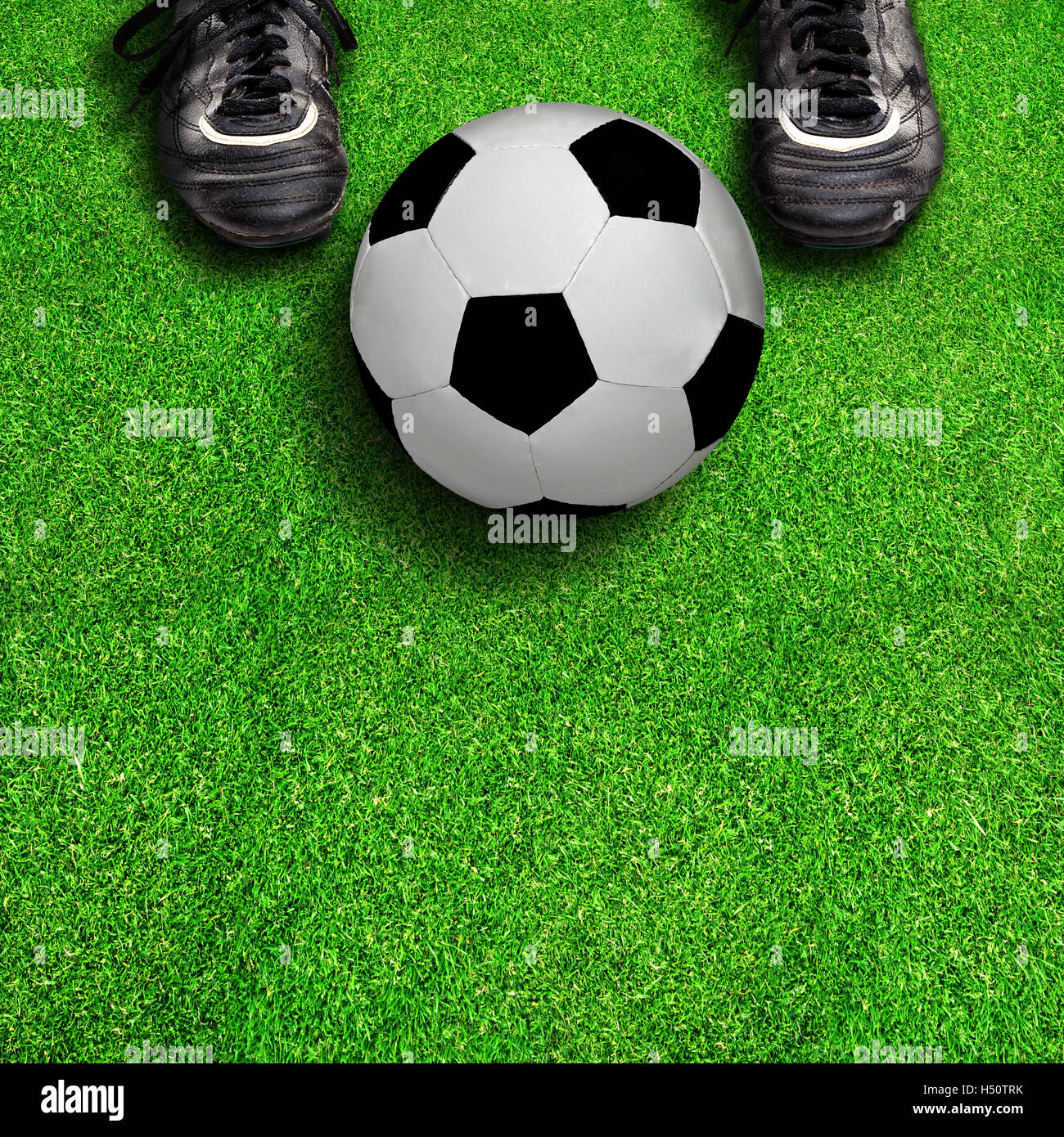 Player standing on field showing soccer cleats with ball and copy space ...