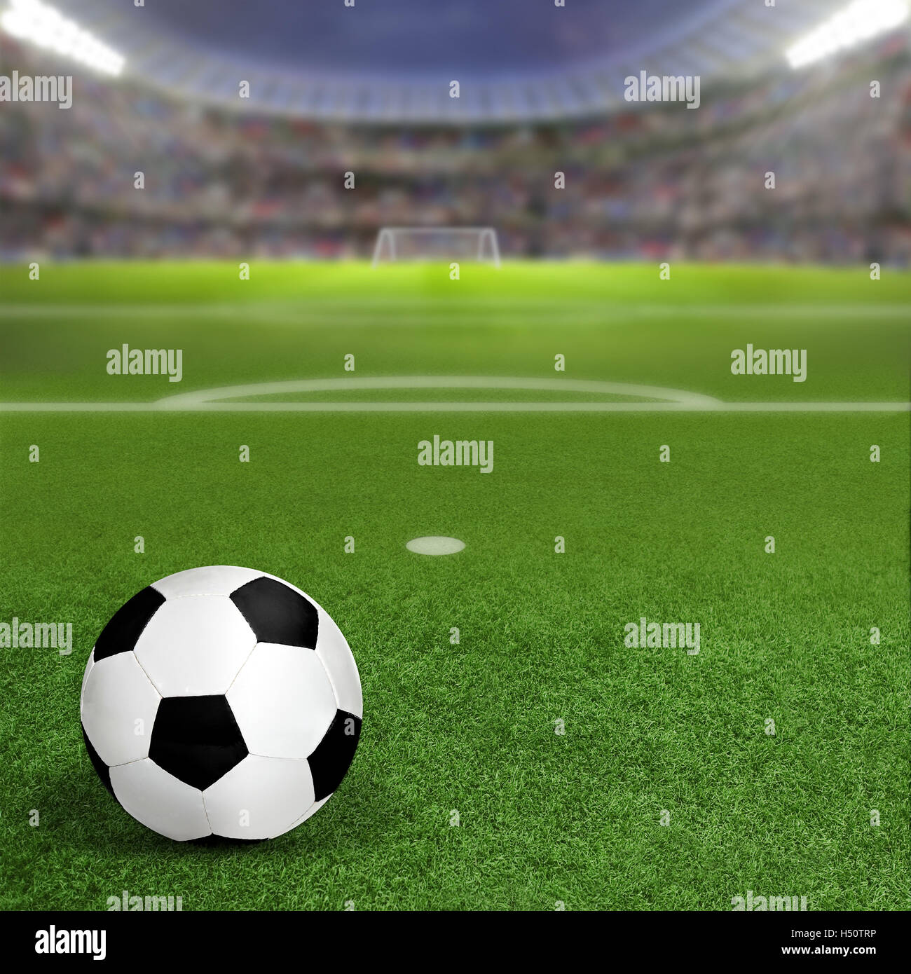 Soccer stadium full of fans in the stands with soccer ball on the field ...