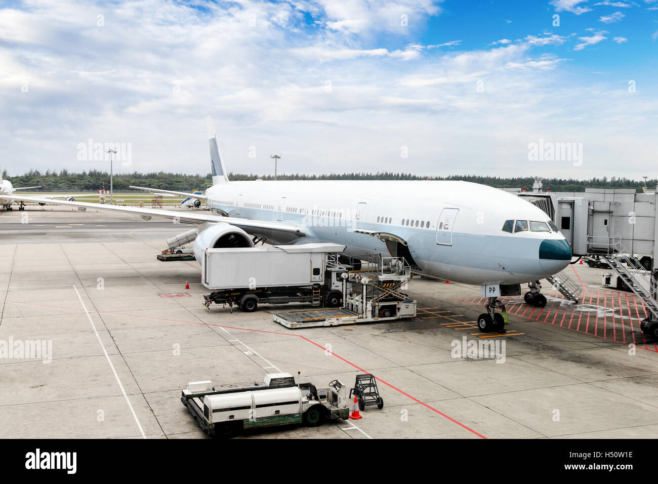 A passenger plane being serviced by ground services before next takeoff ...