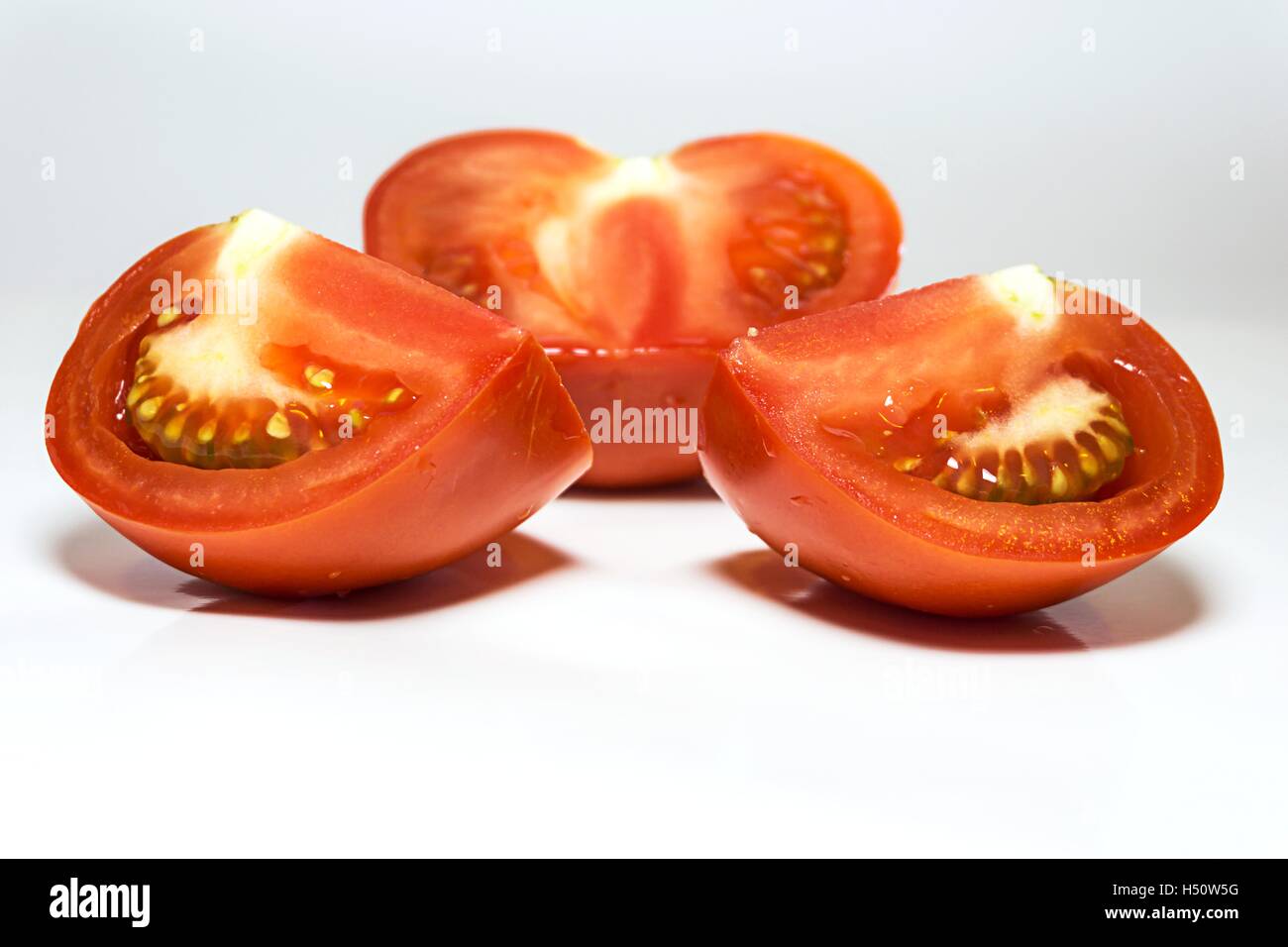 Fresh sliced tomatoes on white background Stock Photo - Alamy