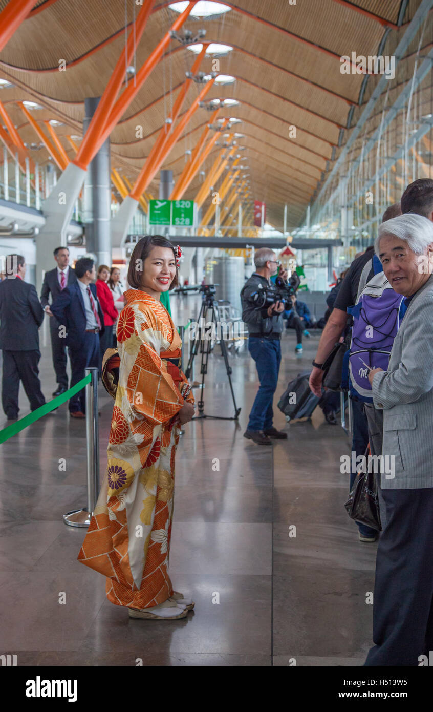 Japanese girl dressed in traditional kimono welcoming passengers and ...