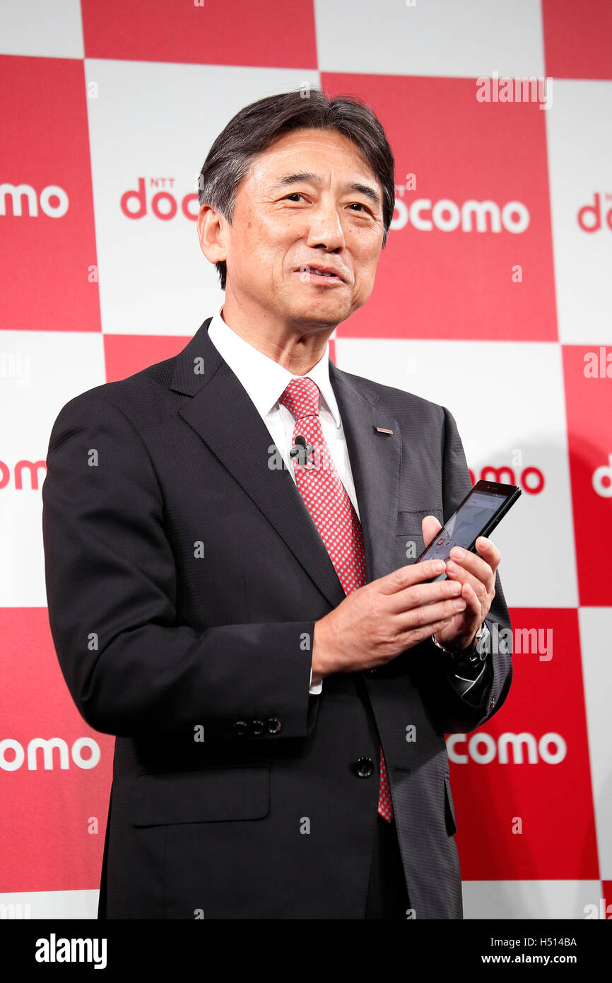 NTT DoCoMo President Kazuhiro Yoshizawa poses for the cameras during a ...