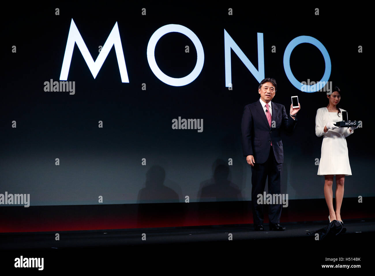 NTT DoCoMo President Kazuhiro Yoshizawa shows their new original ...