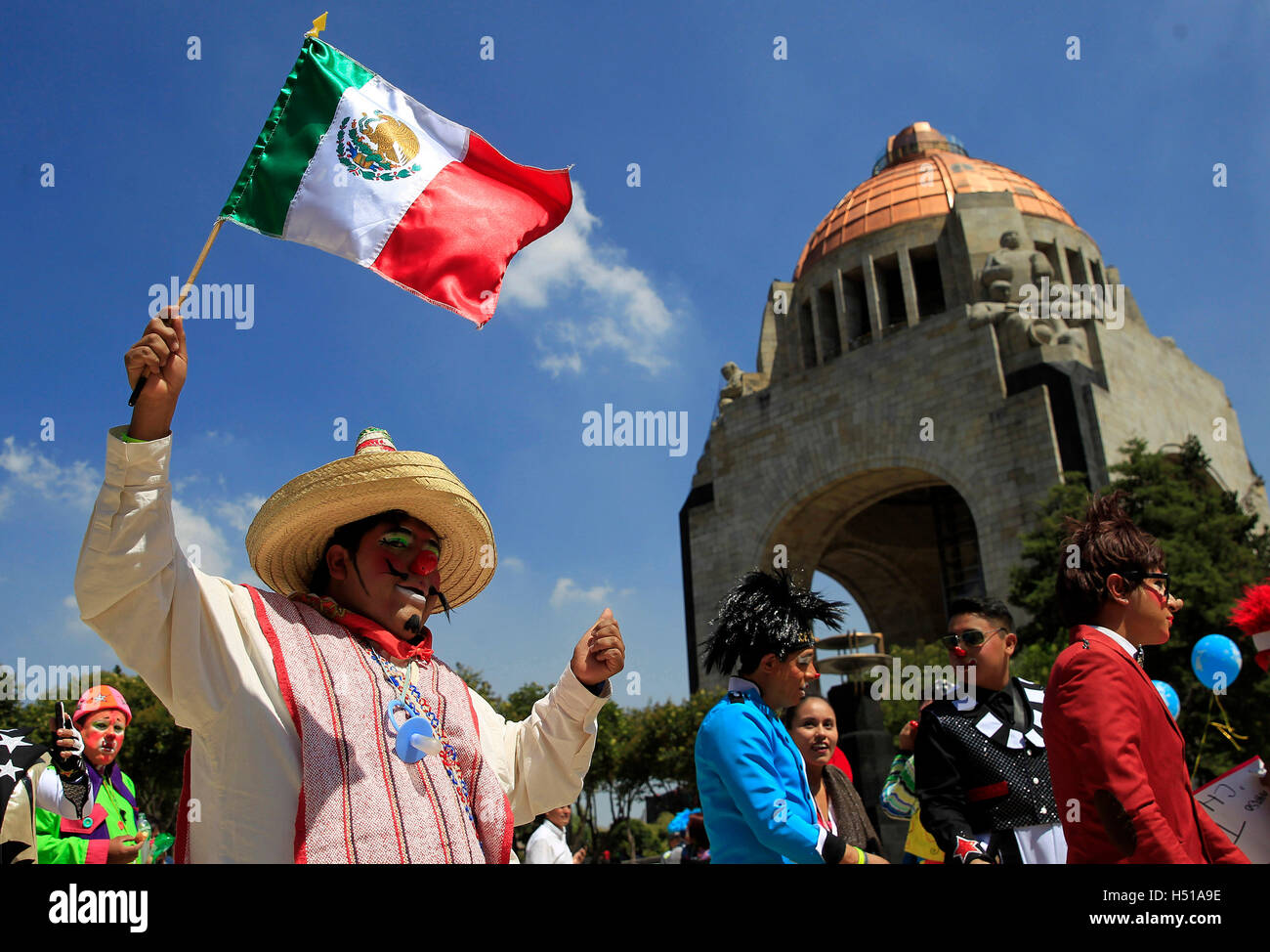 Mexico City, Mexico. 19th Oct, 2016. A clown waves the national flag of ...