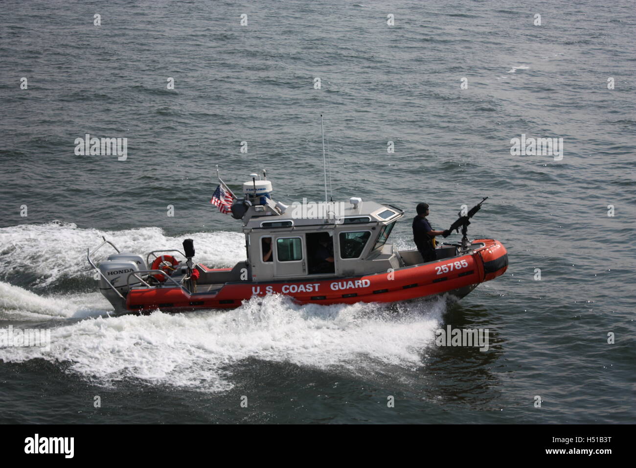 New York life saving power boat with a coast gaurd who has a gun Stock ...