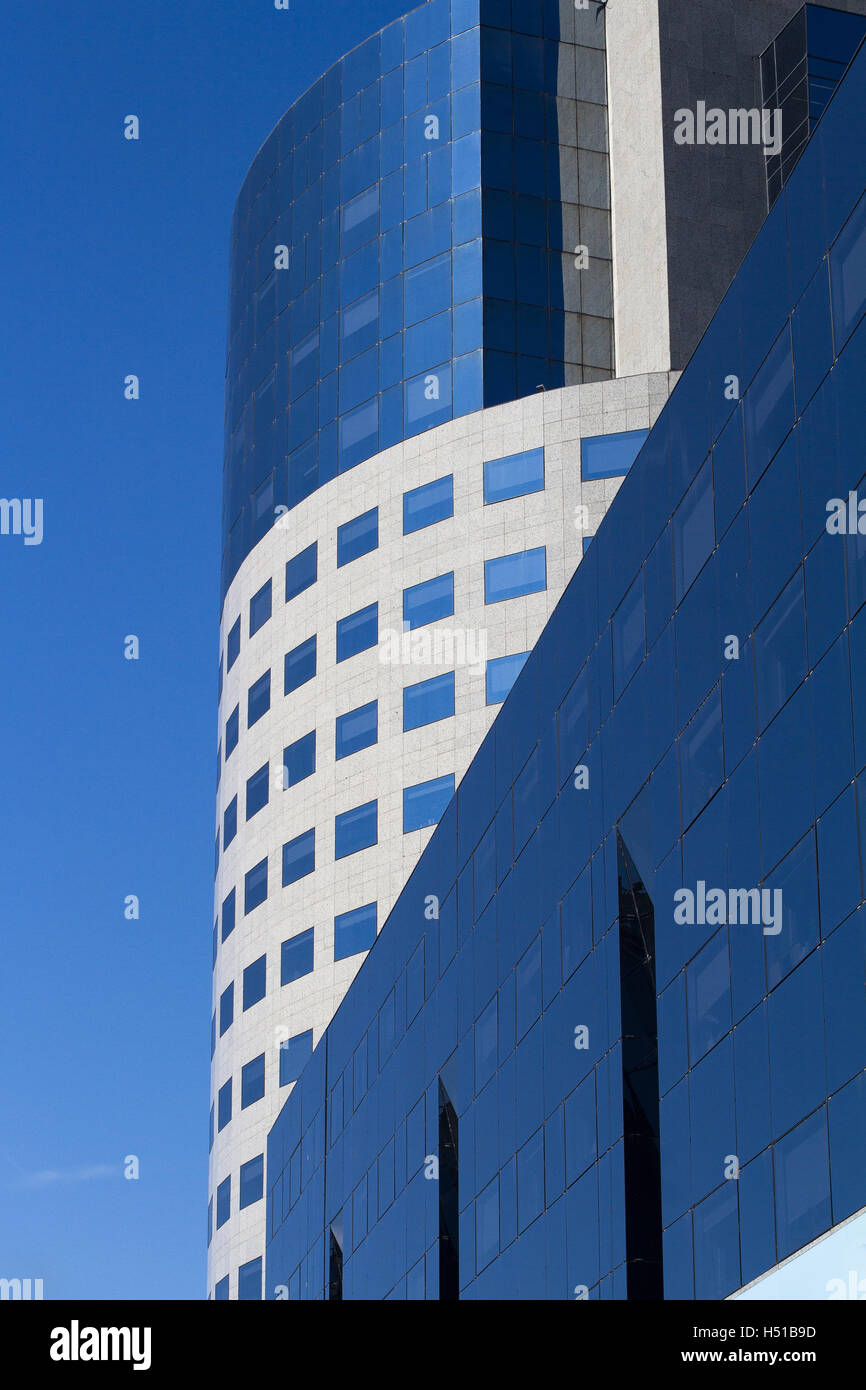 Detail of round city office building in downtown Bucharest with blue ...