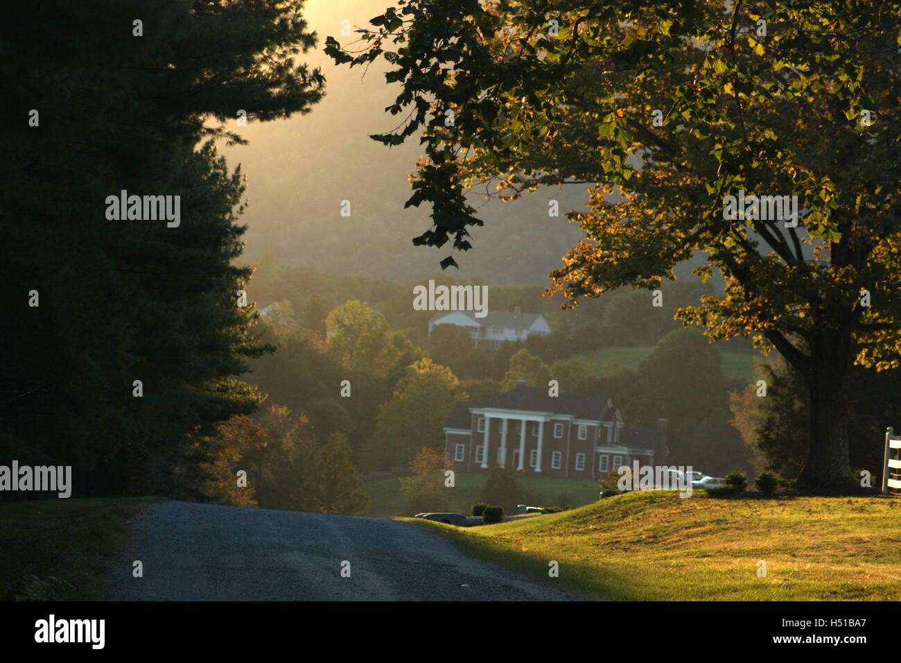 Mansion seen from driveway at sunset Stock Photo - Alamy